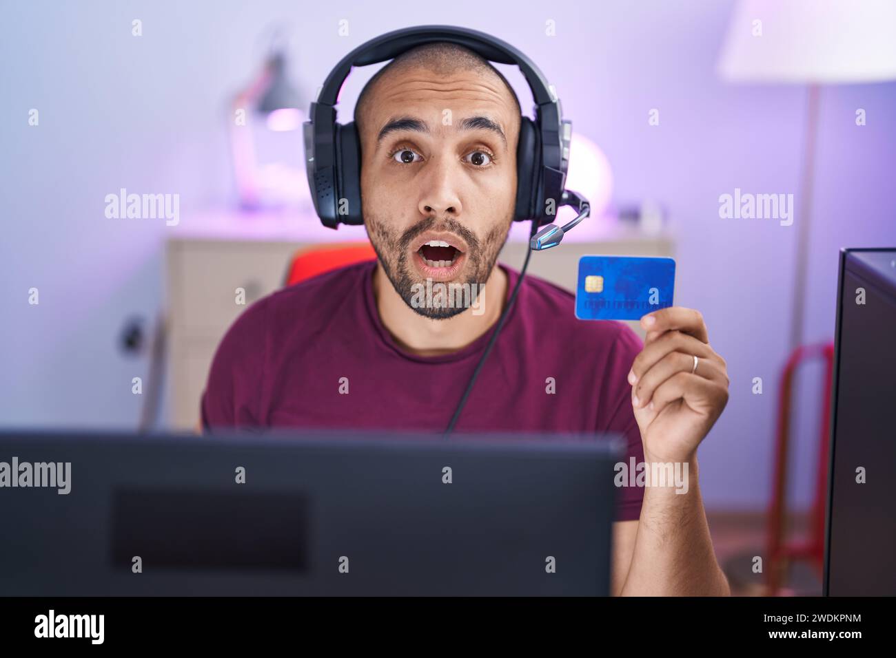 Hispanic man with beard doing online shopping with computer and credit ...