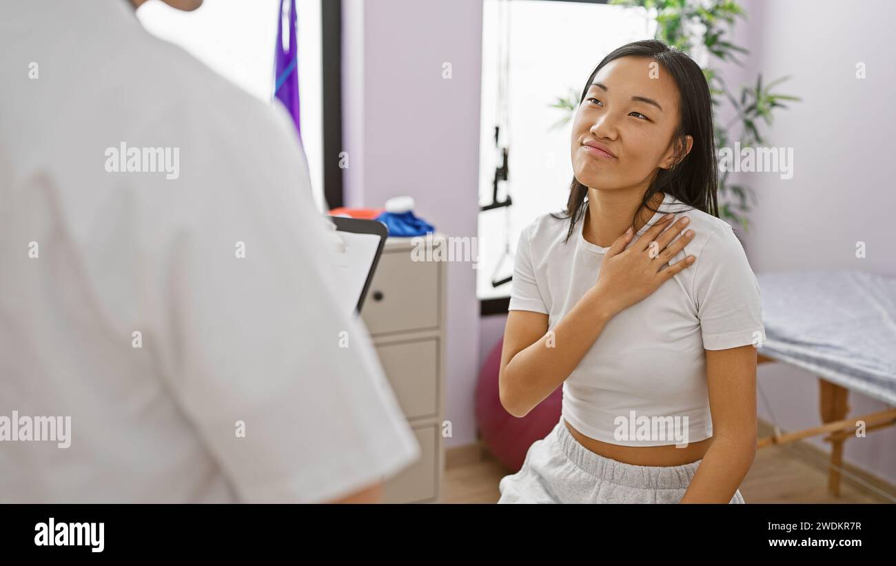 A woman patient expressing discomfort to a doctor at a physiotherapy ...