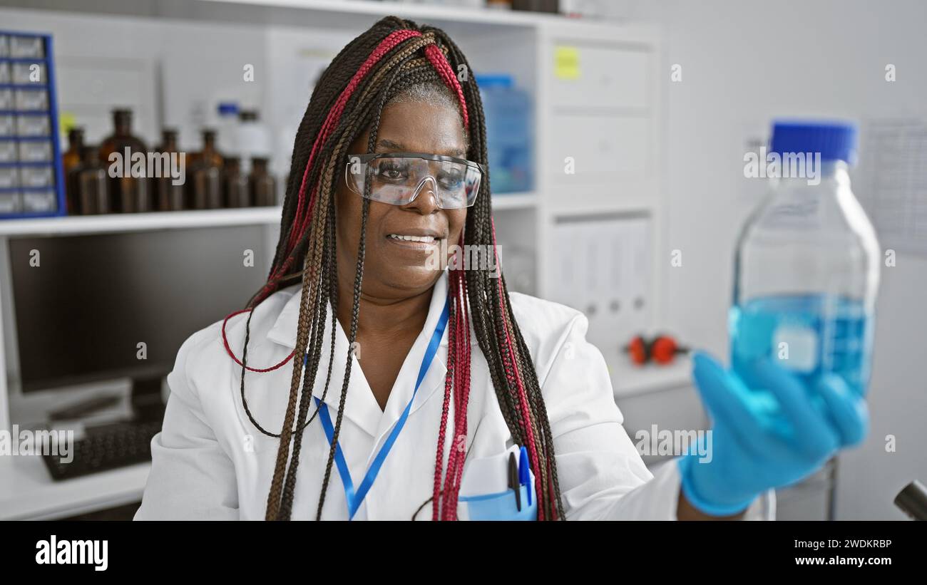 Confident african american female scientist with braids smiling as she ...