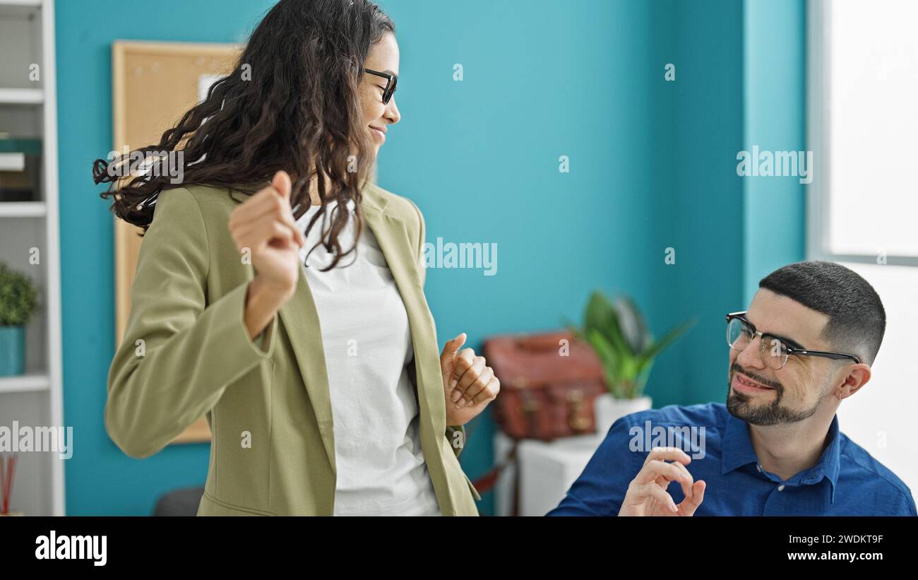 Two workers man and woman working and dancing at the office Stock Photo ...