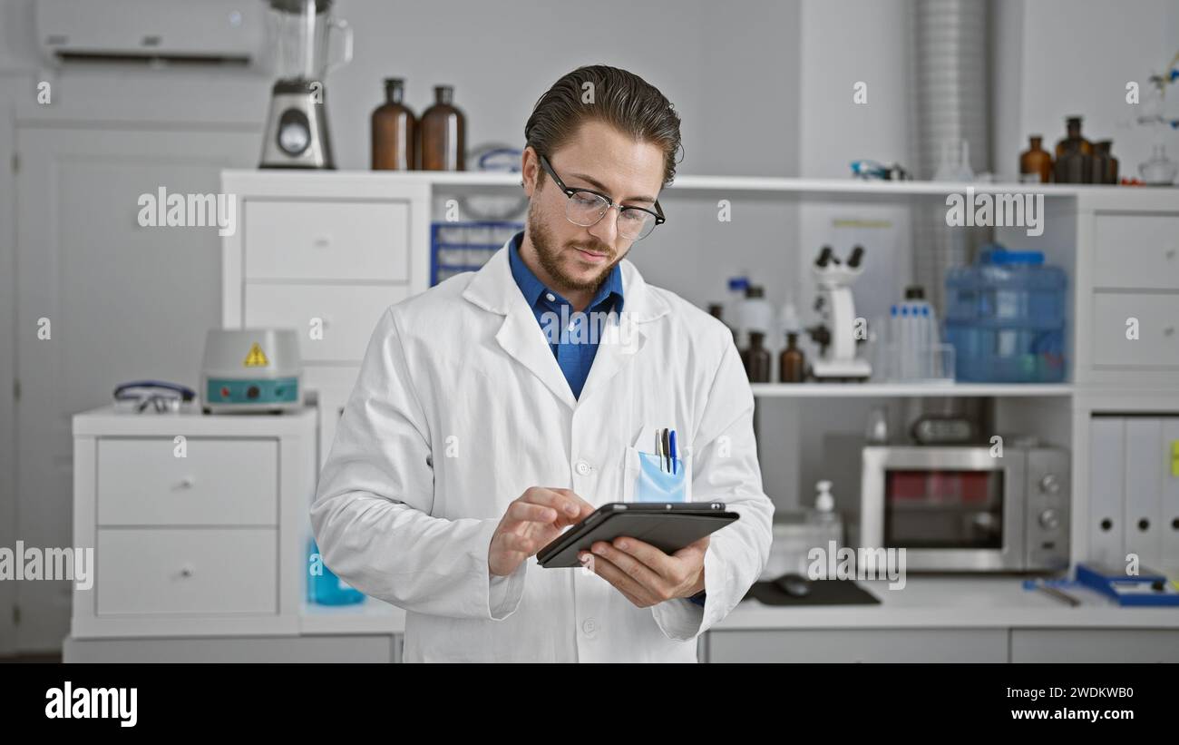 Young hispanic man scientist using touchpad at laboratory Stock Photo - Alamy