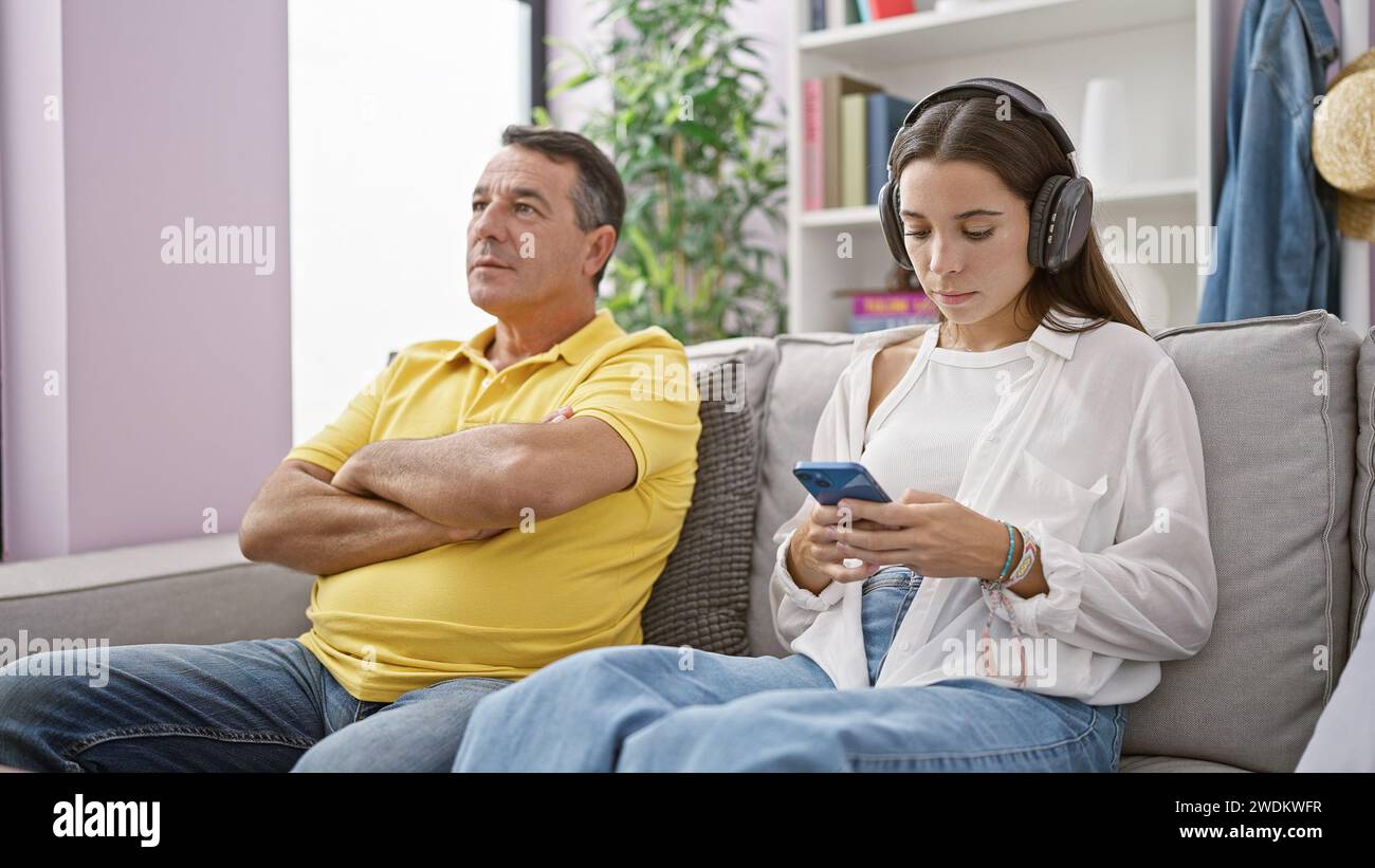 At home, a loving father and his daughter relaxing on a comfortable ...