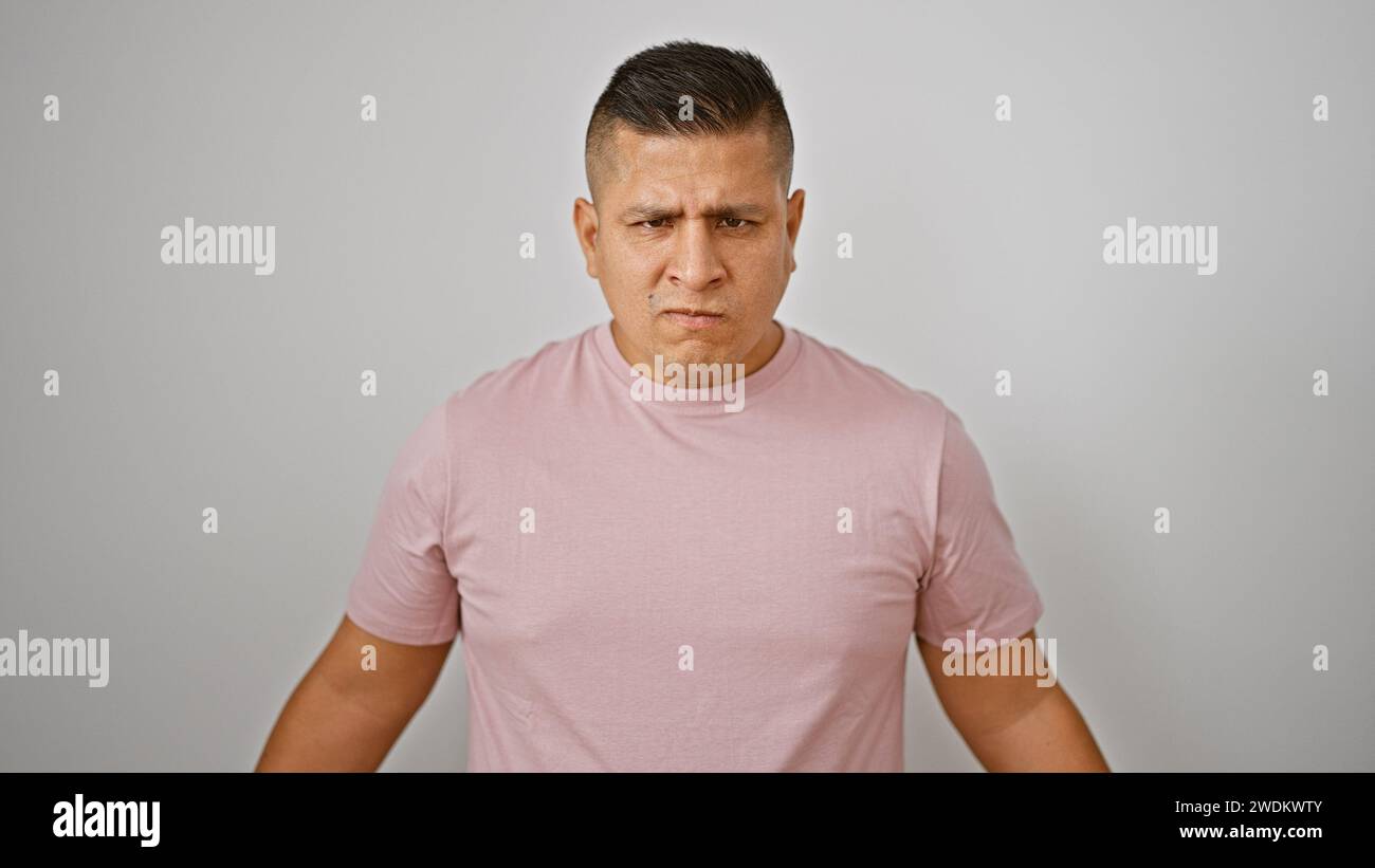Furious young latin man, a picture of raw anger, standing, fiercely ...