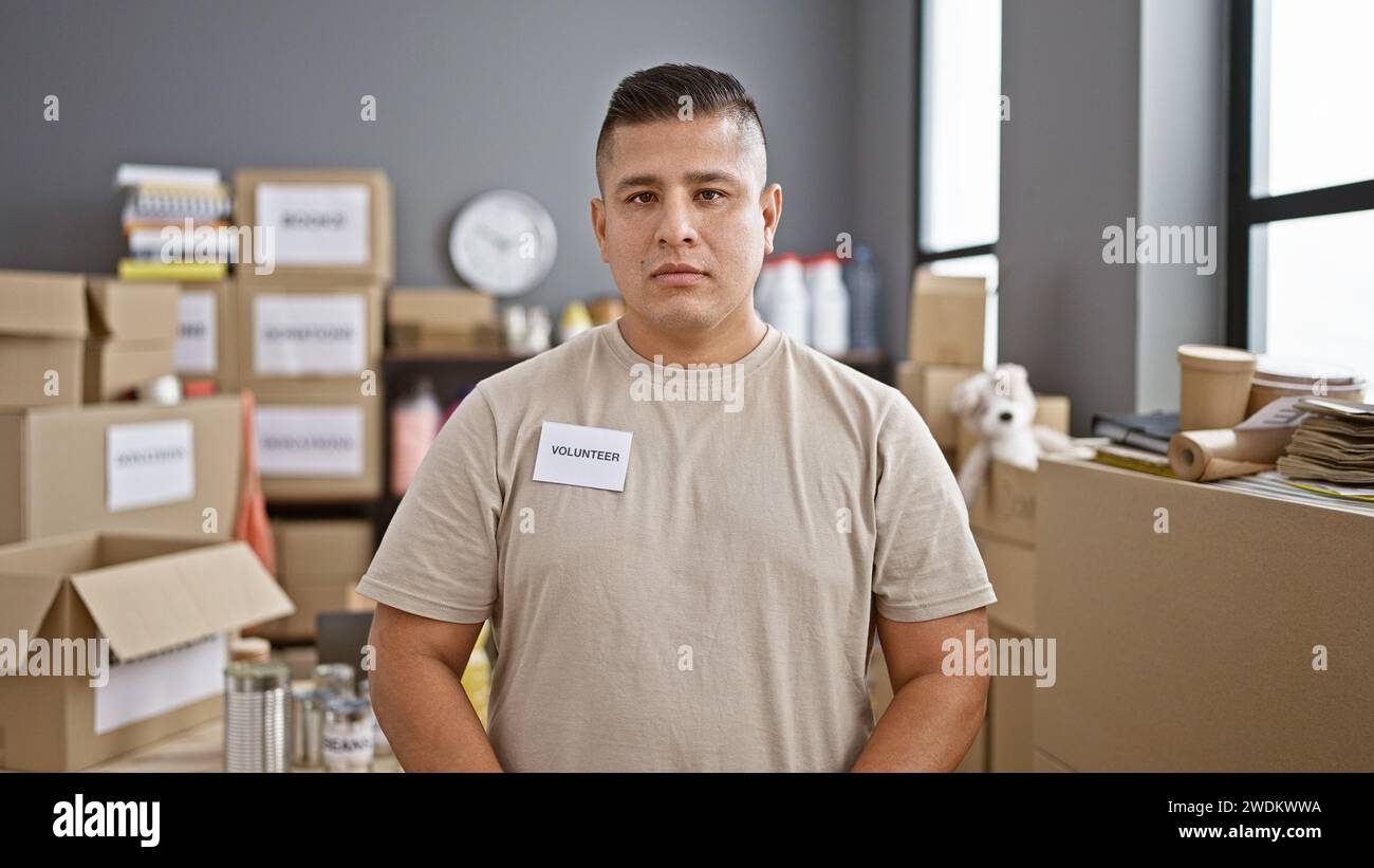 Dedicated young latin man, a steadfast volunteer standing firm ...