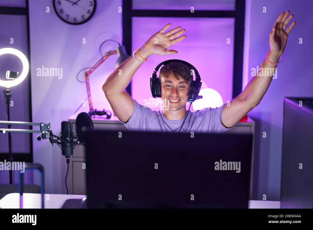 Young caucasian man streamer playing video game with winner expression ...