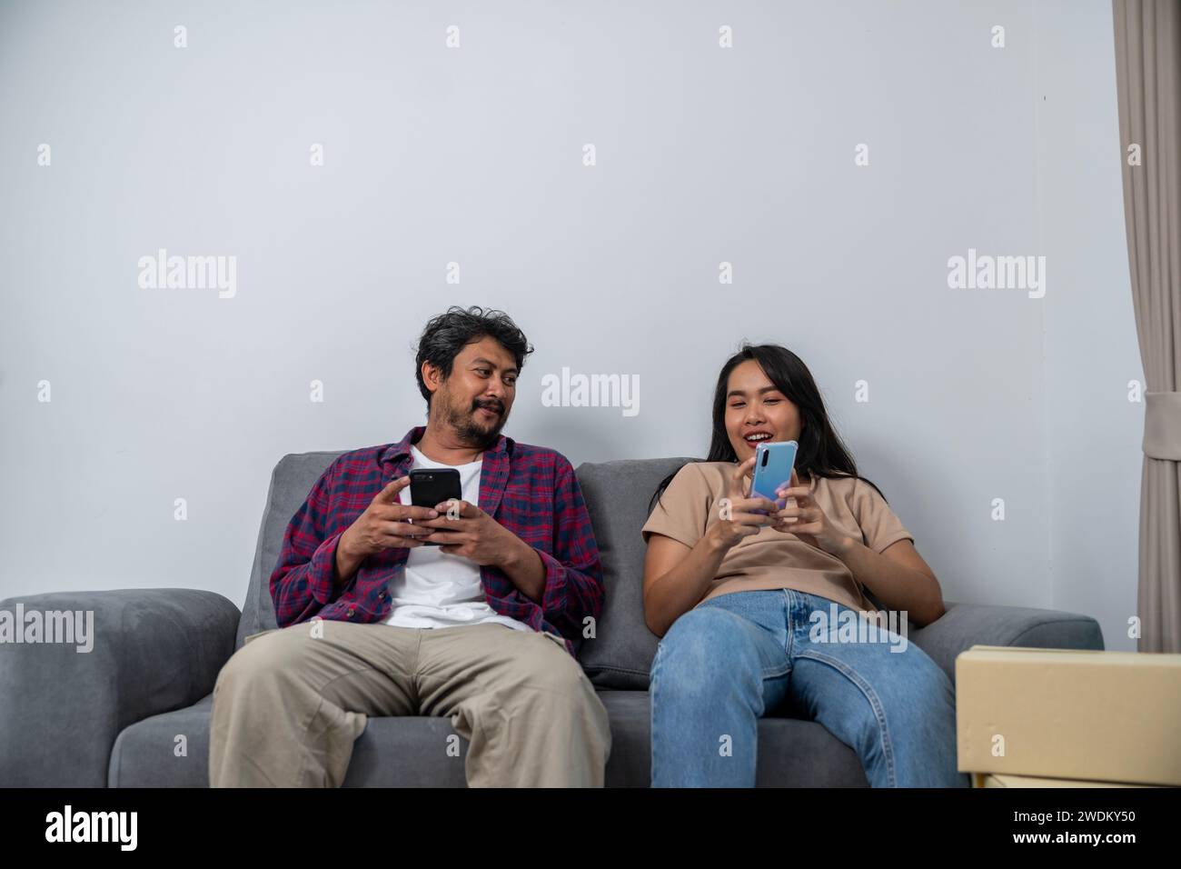 Family couple playing on portable hi-res stock photography and images ...