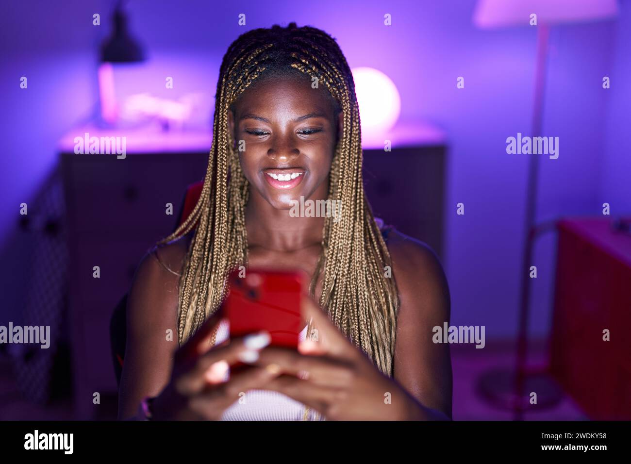 African american woman streamer using smartphone at gaming room Stock ...