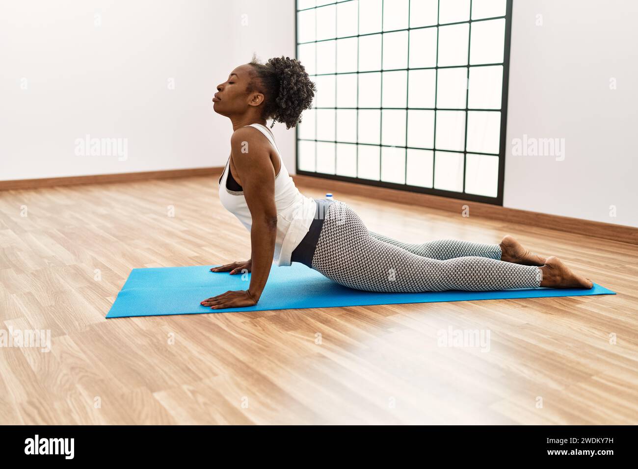 African american woman stretching back at sport center Stock Photo - Alamy