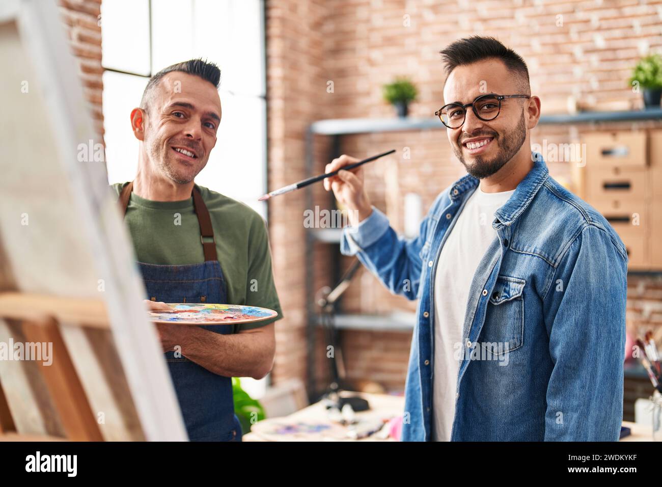 Two men artists smiling confident drawing at art studio Stock Photo - Alamy