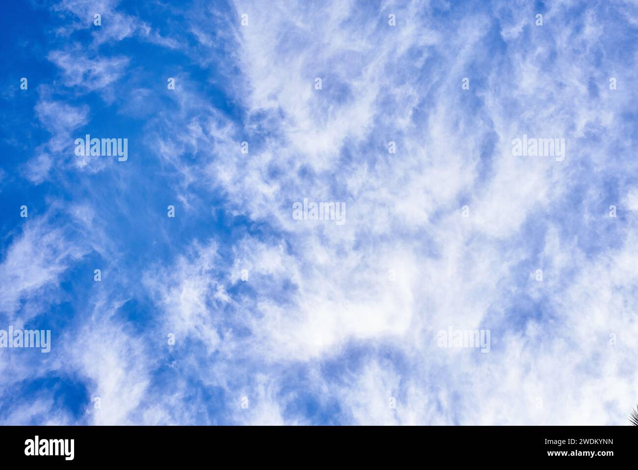 Blue sky with wispy cirrus clouds conveying a sense of tranquility and ...