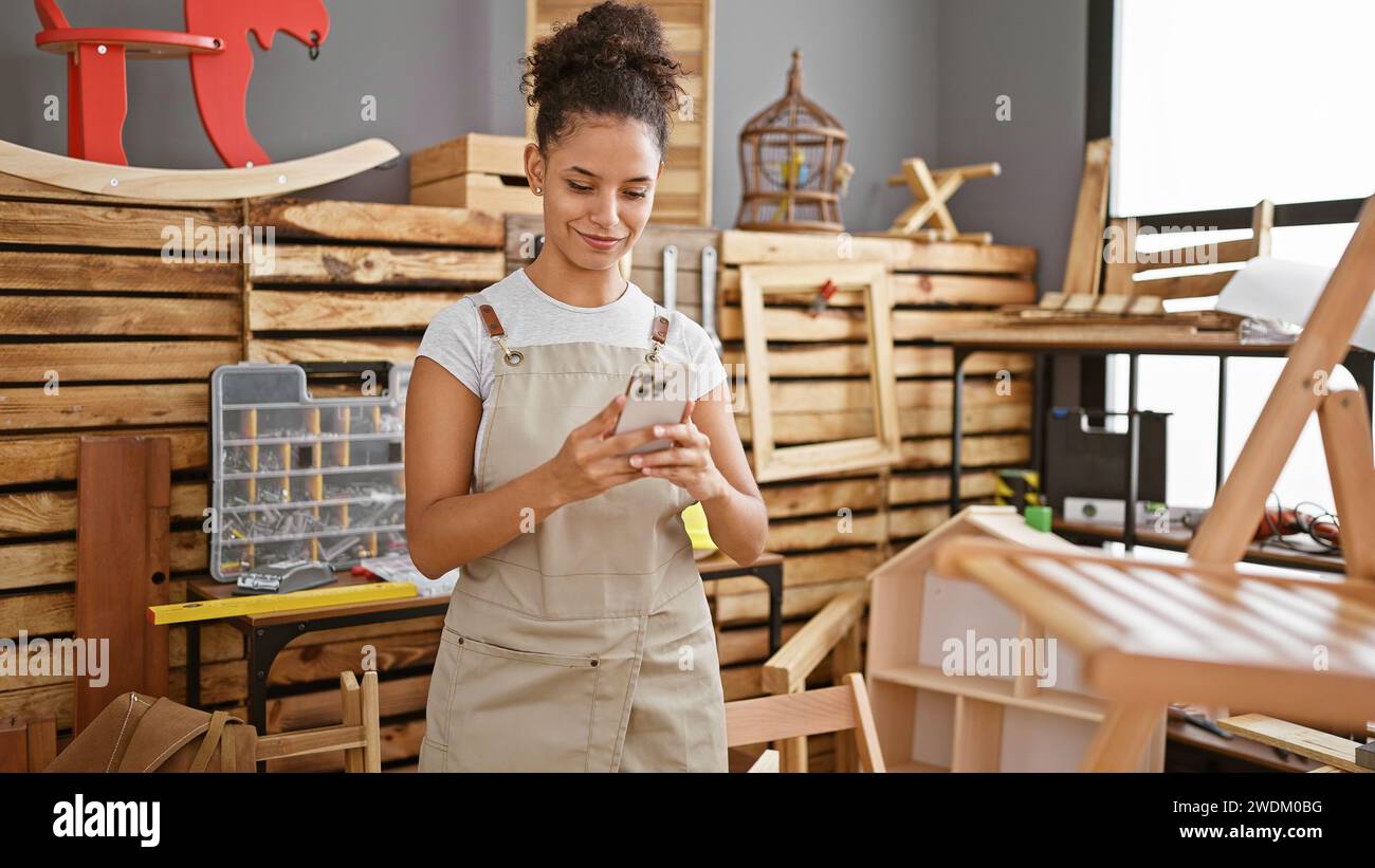 Smiling young hispanic woman carpenter, beautiful as a picture ...