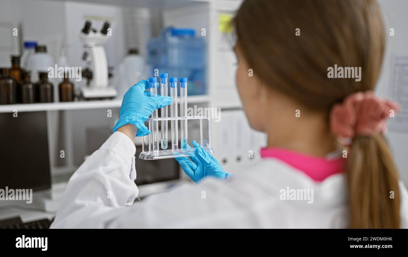 Vibrant young hispanic woman scientist, beautifully engrossed in her ...