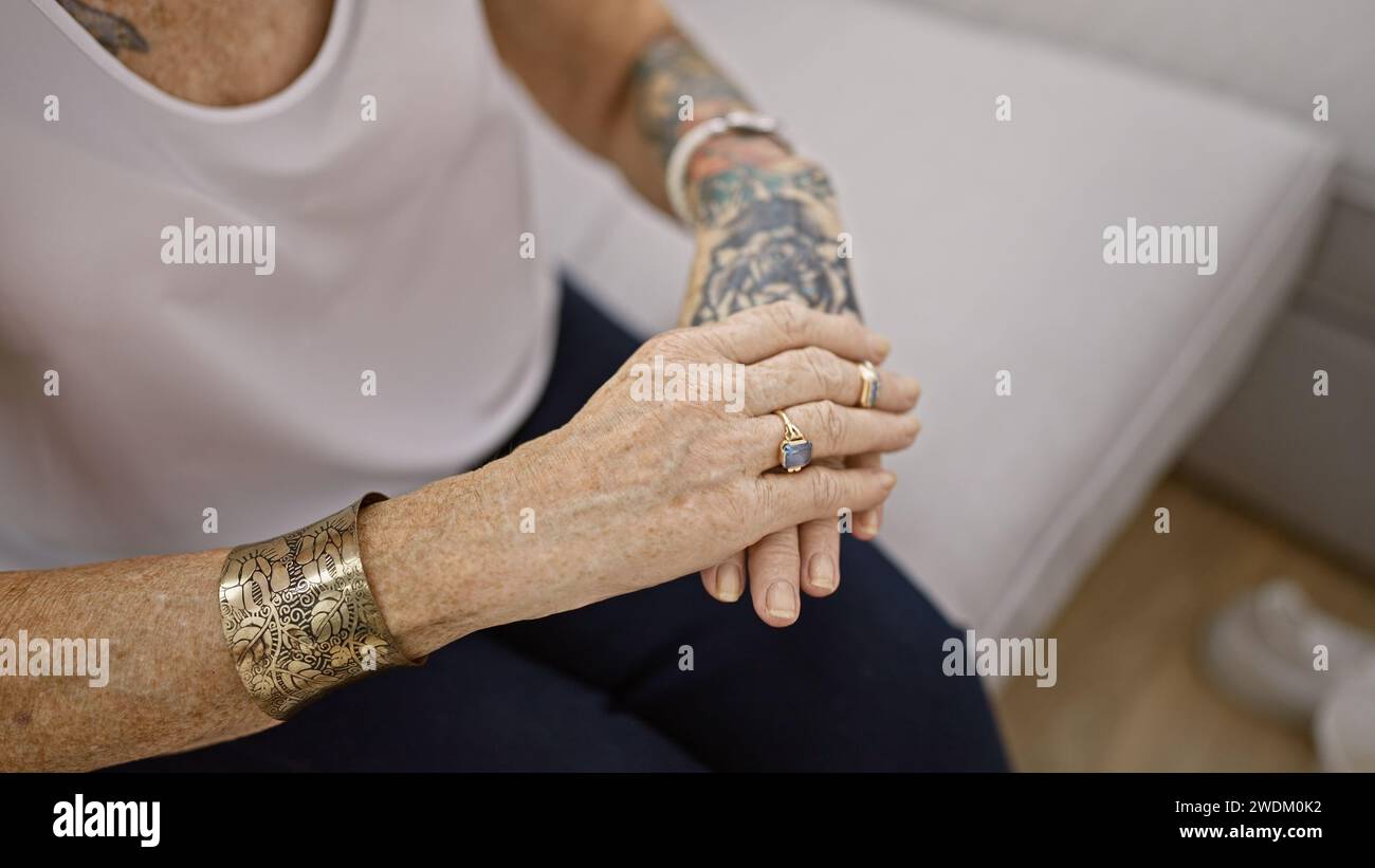 Elderly woman suffering from severe hand pain while sitting on living ...