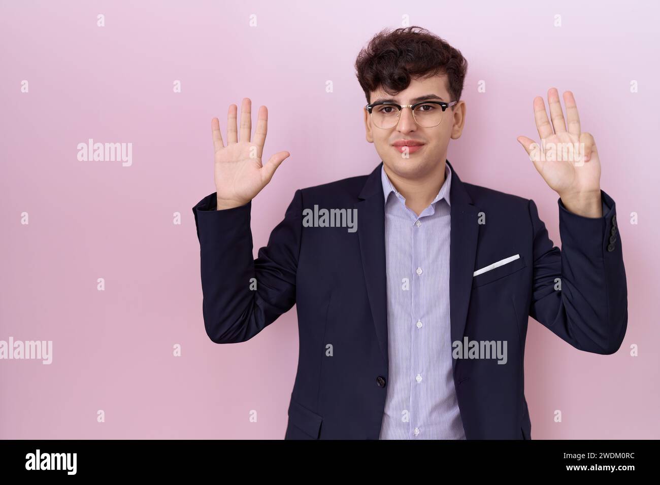 Young non binary man with beard wearing suit and tie showing and ...