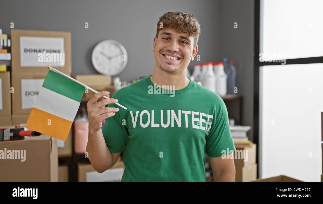 Smiling young hispanic man volunteering at a charity center, proudly ...