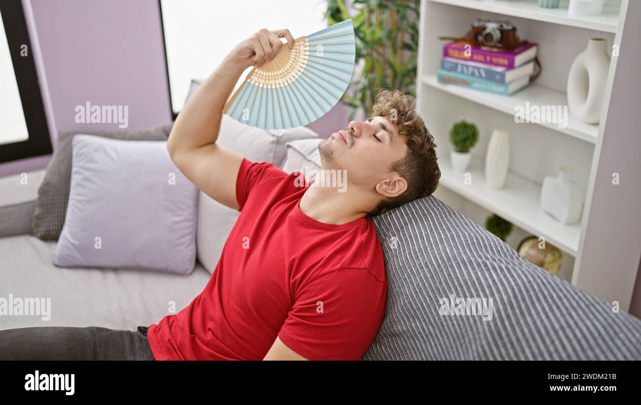 Hot weather woes, young hispanic man suffers, fanning himself with ...