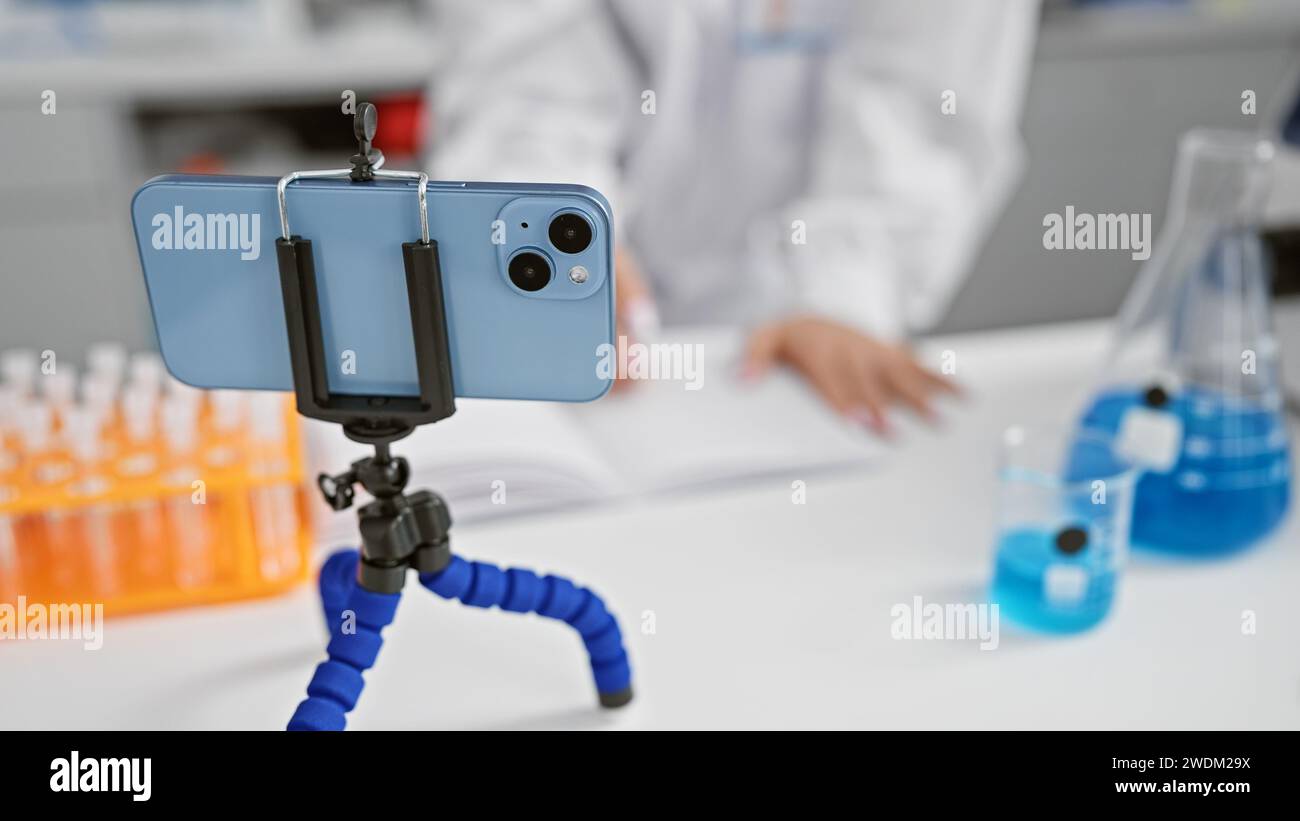 Female scientist's hands busy taking notes while engaging in a video ...