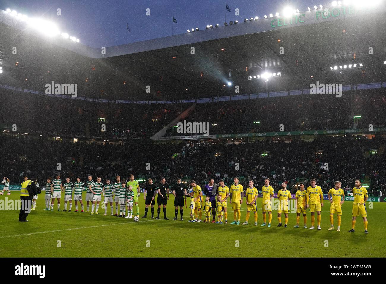 Celtic and Buckie Thistle players line up on the pitch ahead of the ...