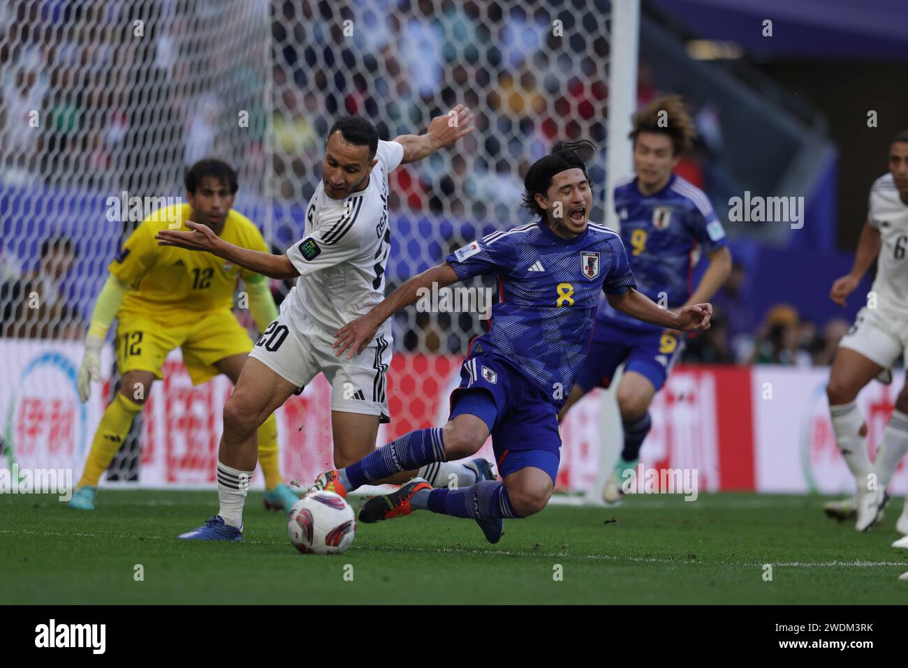 Qatar, Al Rayyan 19 January 2024 - Takumi Minamino of Japan and Osama Rashid of Iraq in action ...