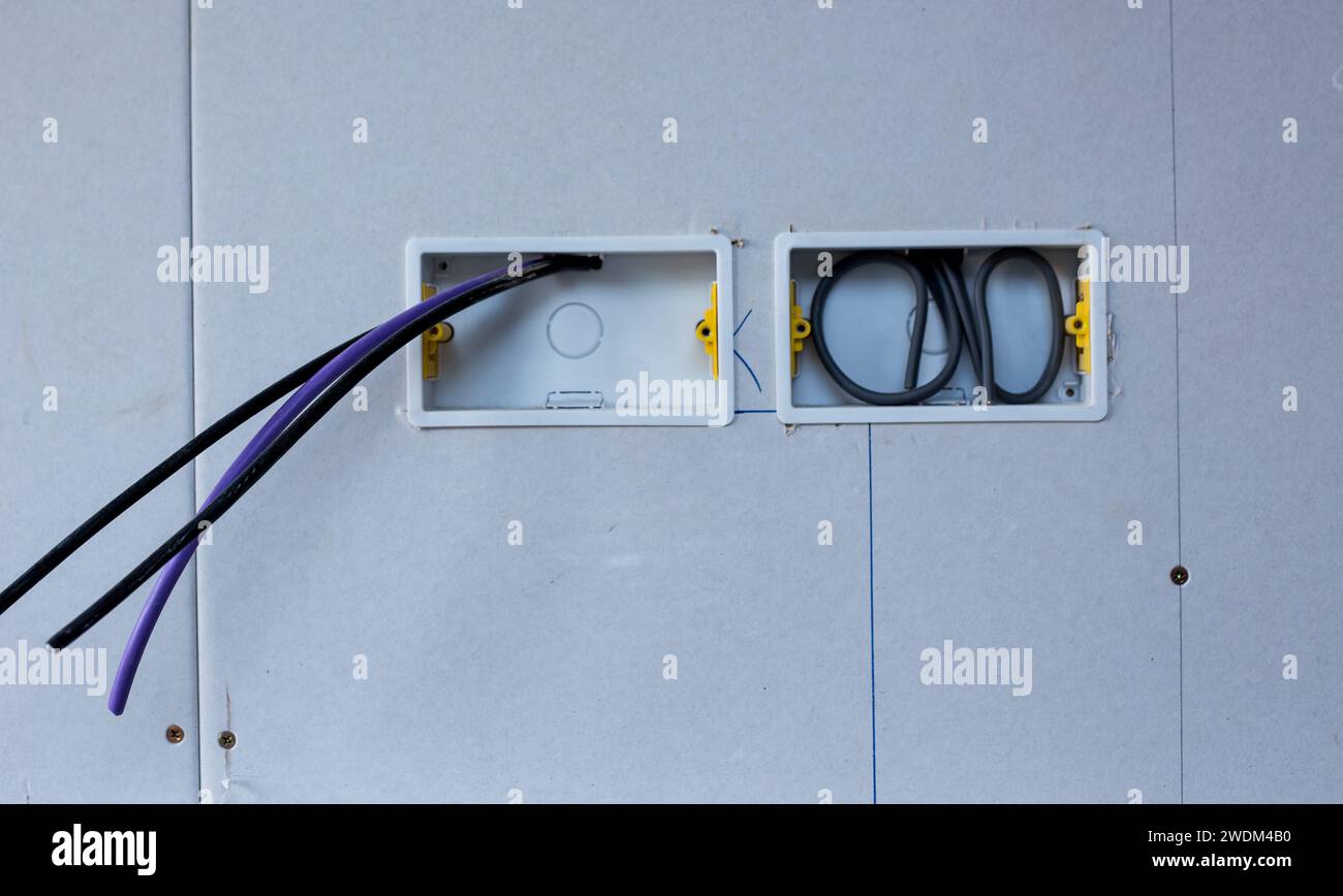 Double plastic socket back plates in a plasterboard wall with satellite ...