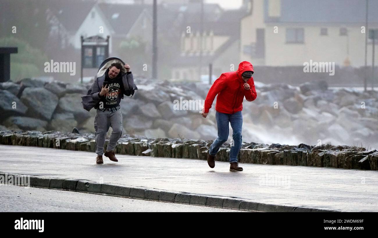 People walking in high winds at Salthill, Galway, during Storm Isha. A ...