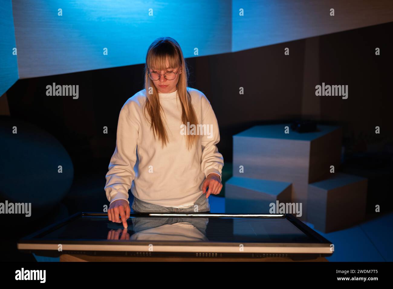 Adolescent girl using touch screen display, skillfully searching ...