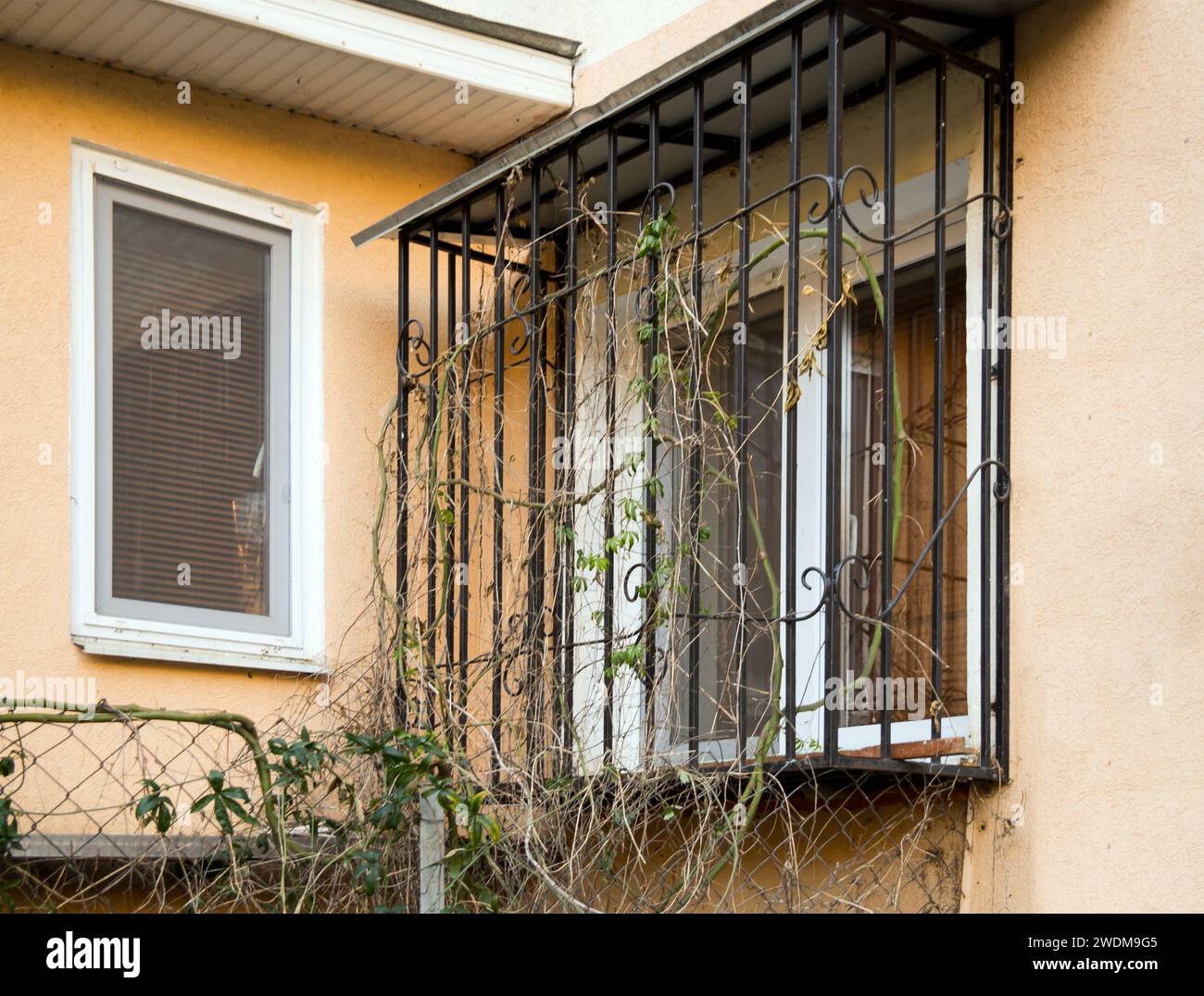 The first floor window is closed with a metal lattice box Stock Photo ...
