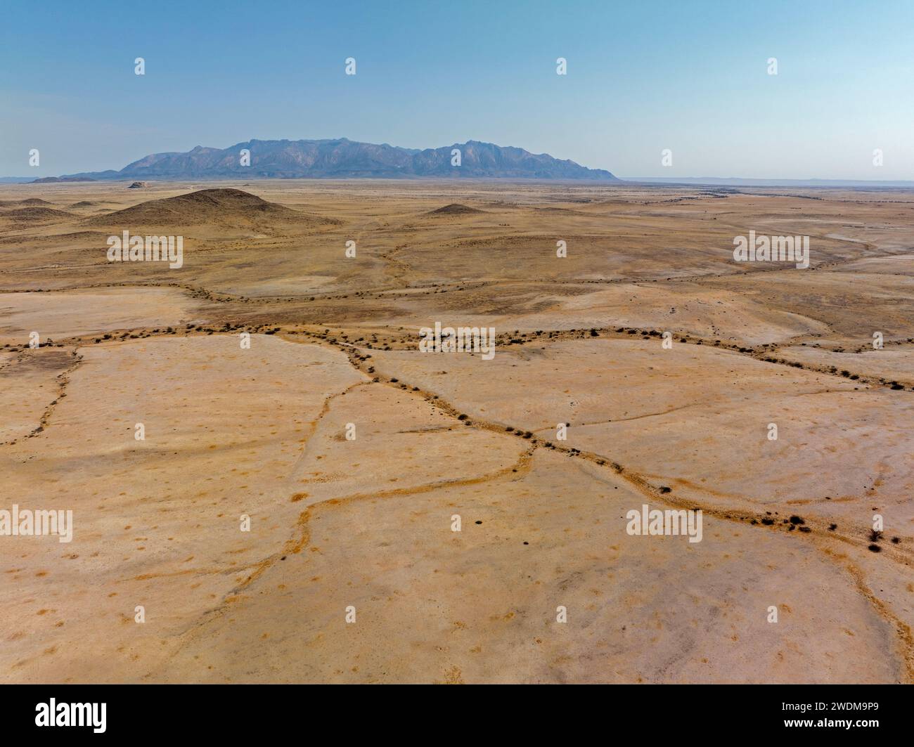 Aerial view of a desert landscape with dried riverbeds around the ...
