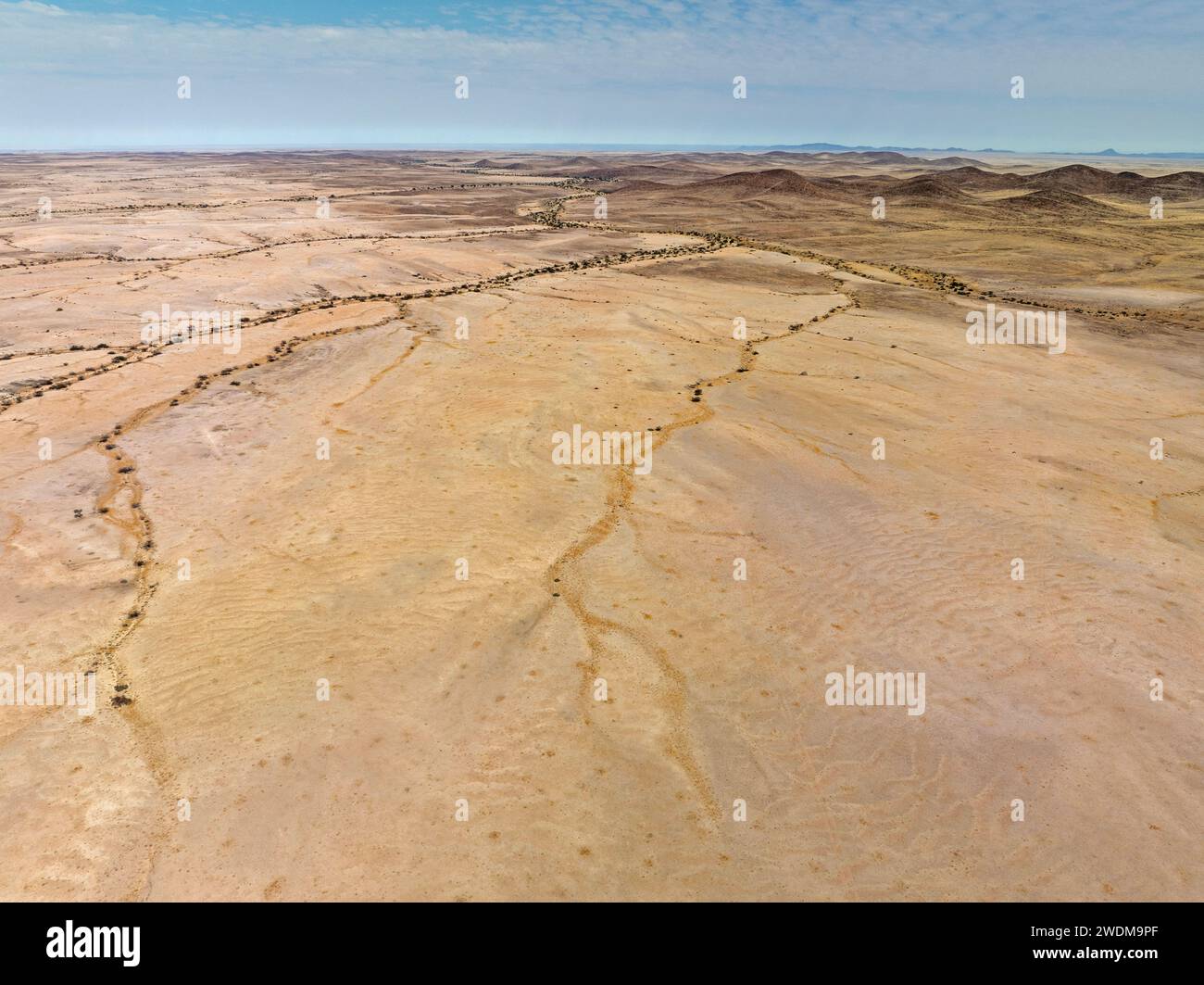Aerial view of a desert landscape with dried riverbeds around the ...