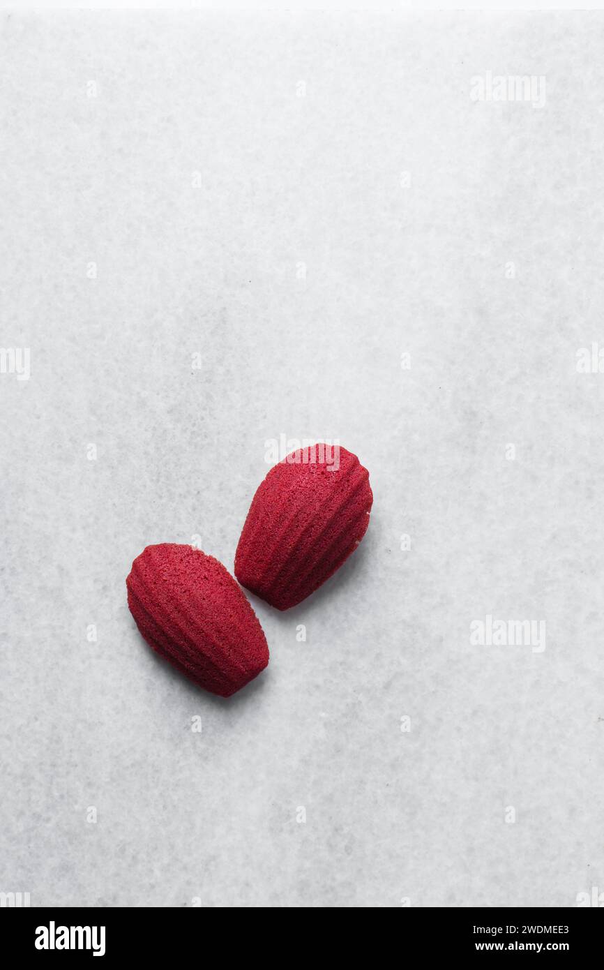 Red velvet madeleines on a marble tray, red madeleines cake or cookies ...