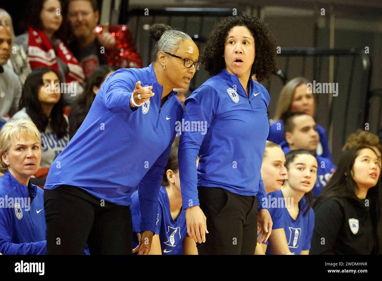 Duke head coach Kara Lawson listens to associate head coach Tia Jackson ...