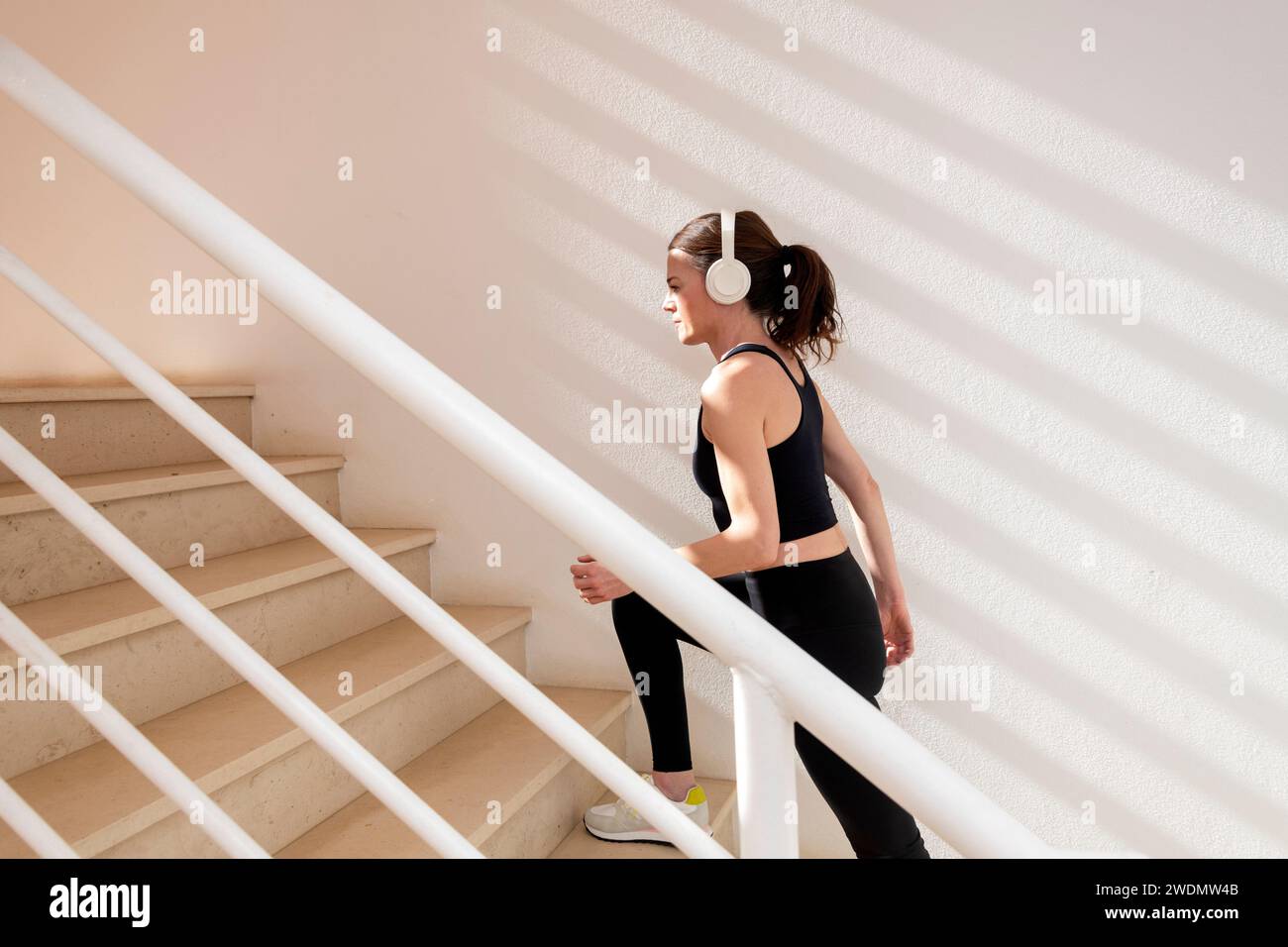 Sporty woman running up stairs Stock Photo - Alamy