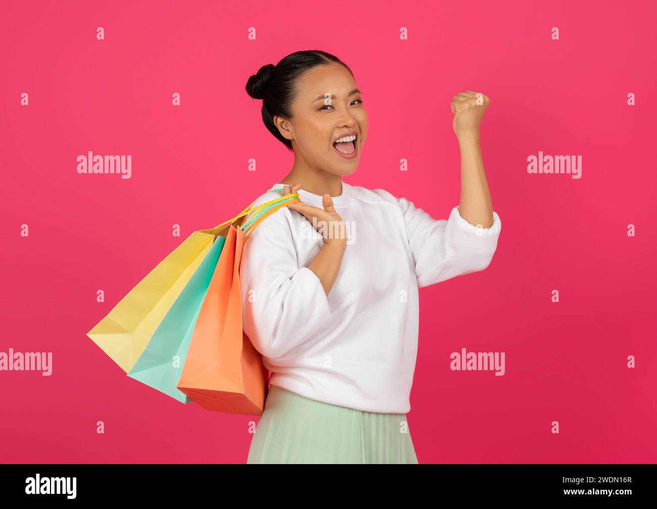 Big Discounts. Happy young asian woman carrying shopping bags and ...