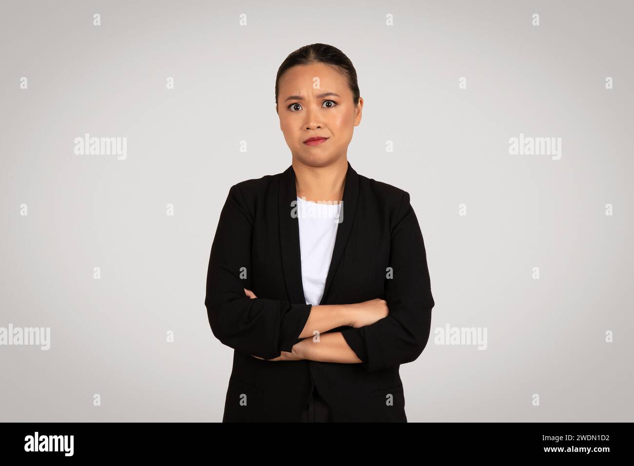 Professional woman in business attire looking skeptical and concerned ...