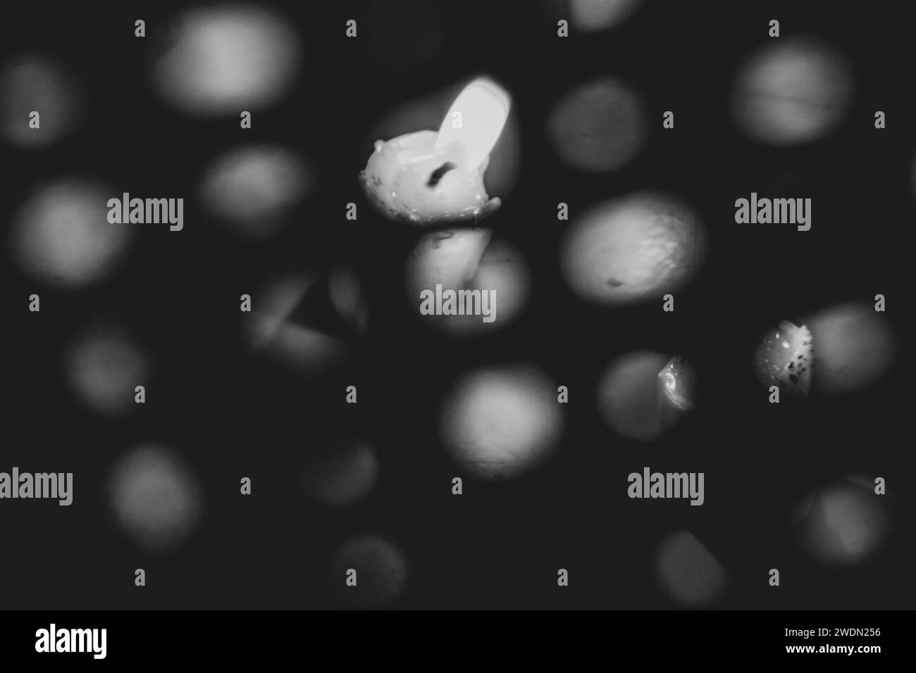 Candles in the dark shine through the mesh, candle flame, fire, without ...