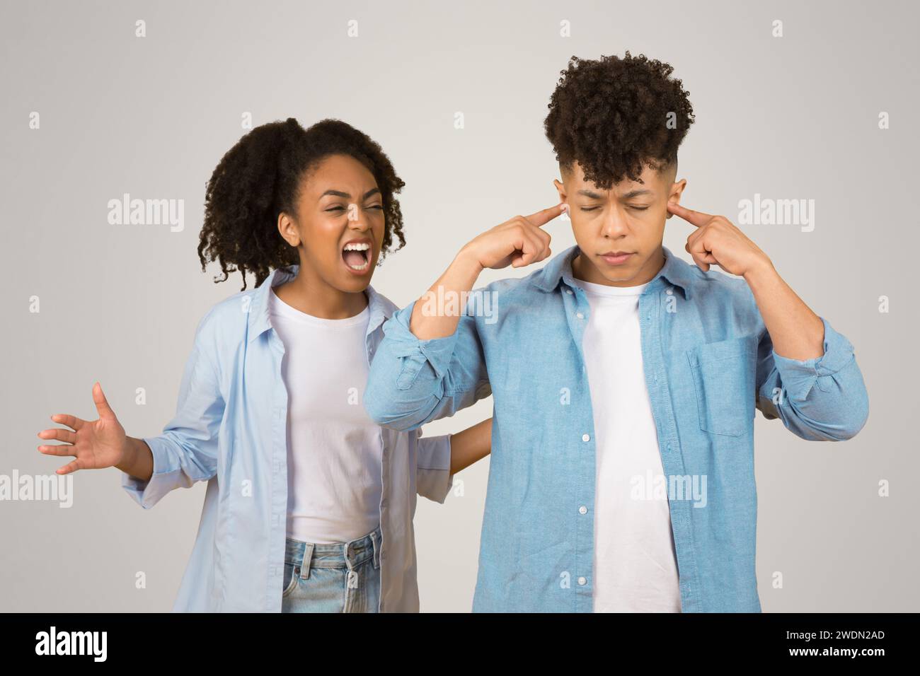 Two young individuals, a cheerful lady shouting animatedly and a man ...