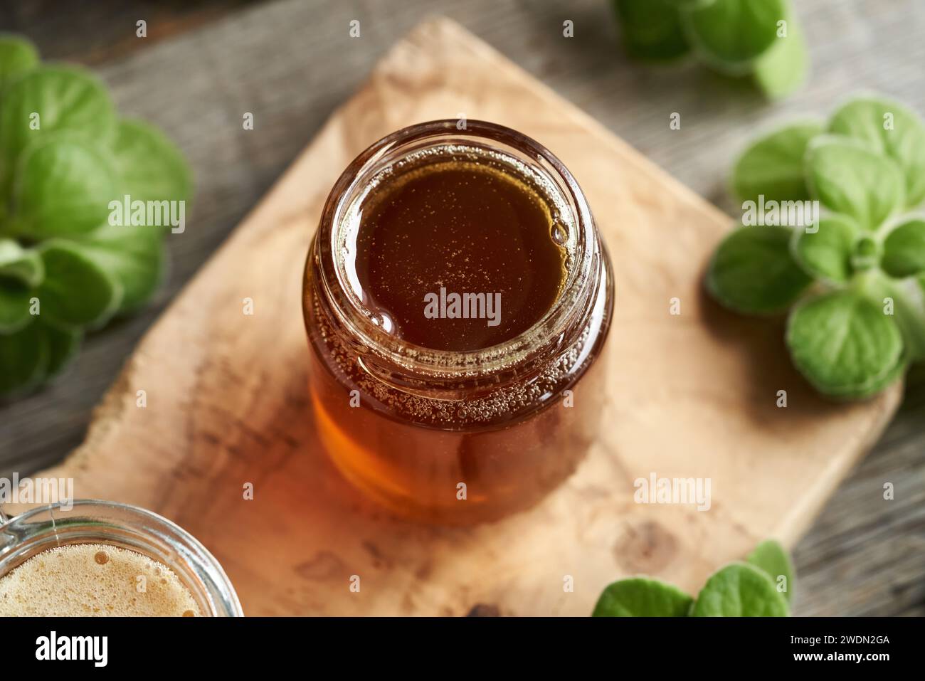 A jar of homemade herbal syrup for common cold, made from fresh ...