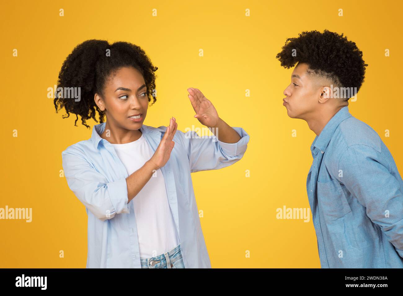 A teenage girl with a defensive hand gesture seems to be cautiously ...
