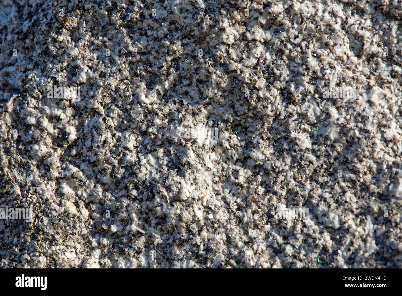 Close up landscape format photograph of the granular surface of granite ...