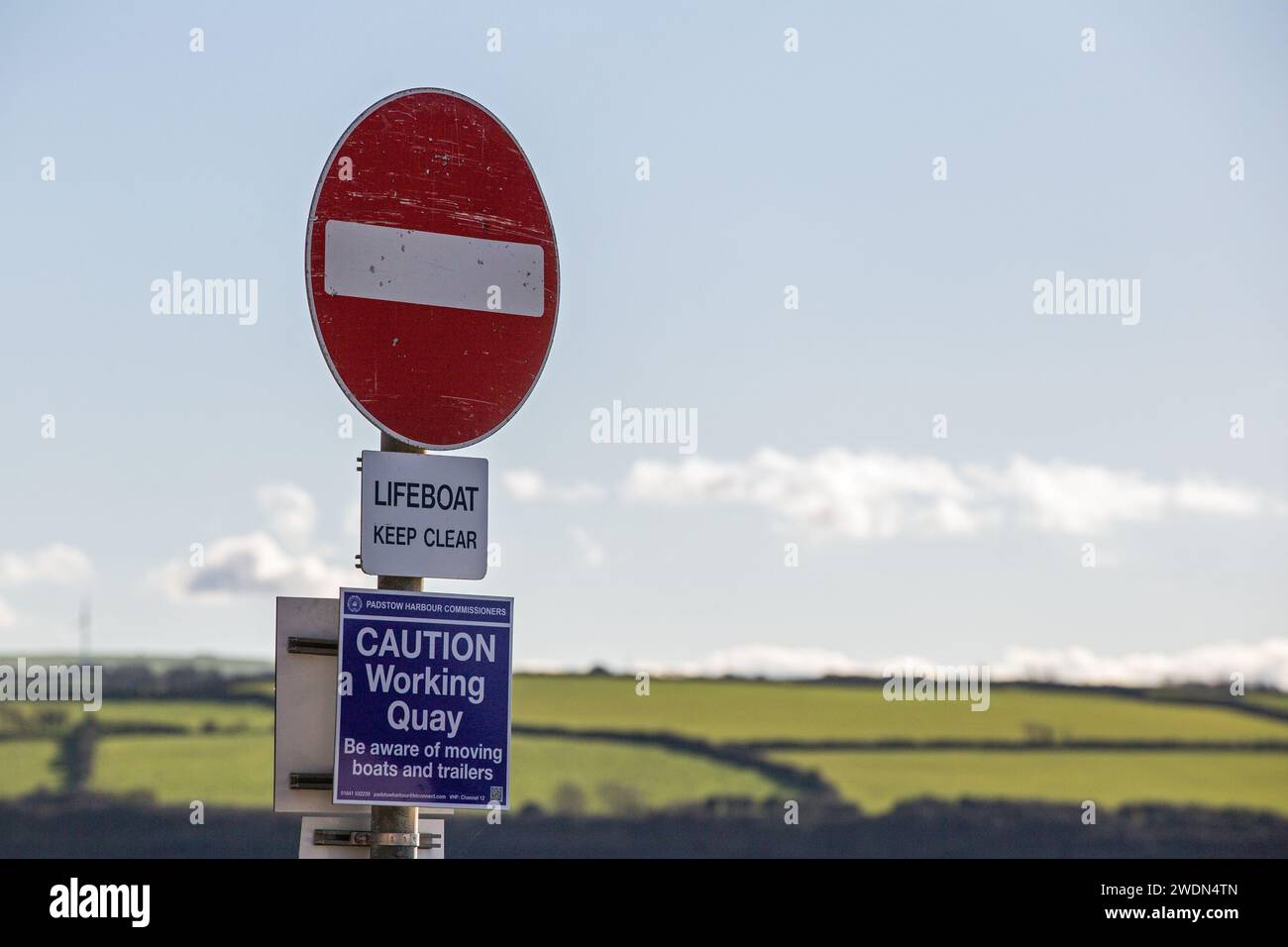 A red and white "no entry" sign shares a post with a "Lifeboat keep ...