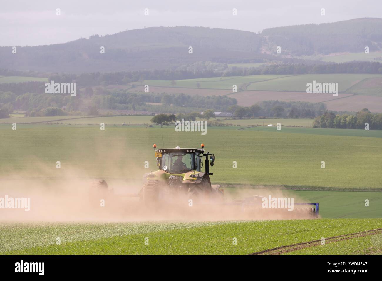 Clouds of Dust Following a Claas Tractor with Dalbo Rollers on Farmland ...