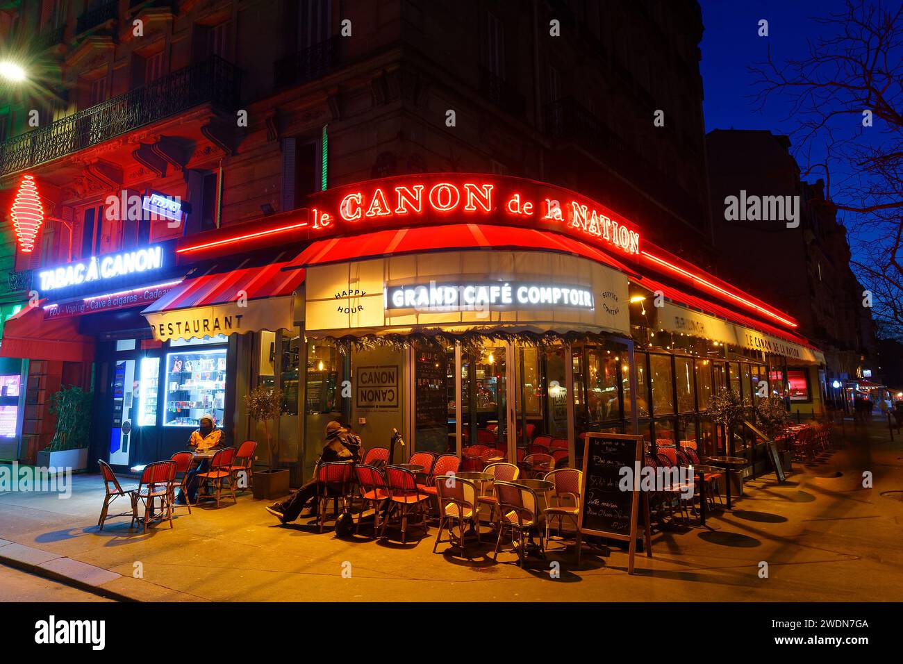 The traditional French cafe brasserie Le Canon de la Nation at night.It ...
