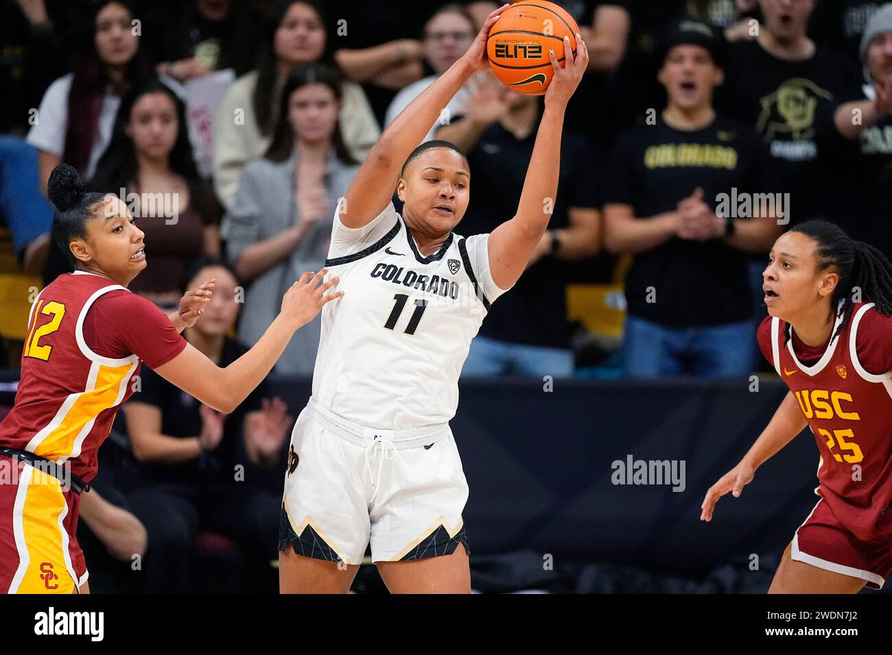 Colorado forward Quay Miller, center, pulls in a loose ball between ...