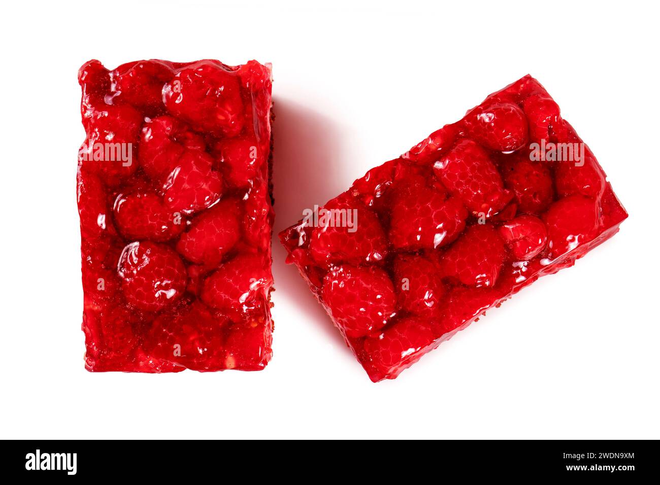 Two golden brown raspberry tarts, freshly baked and glistening with a ...