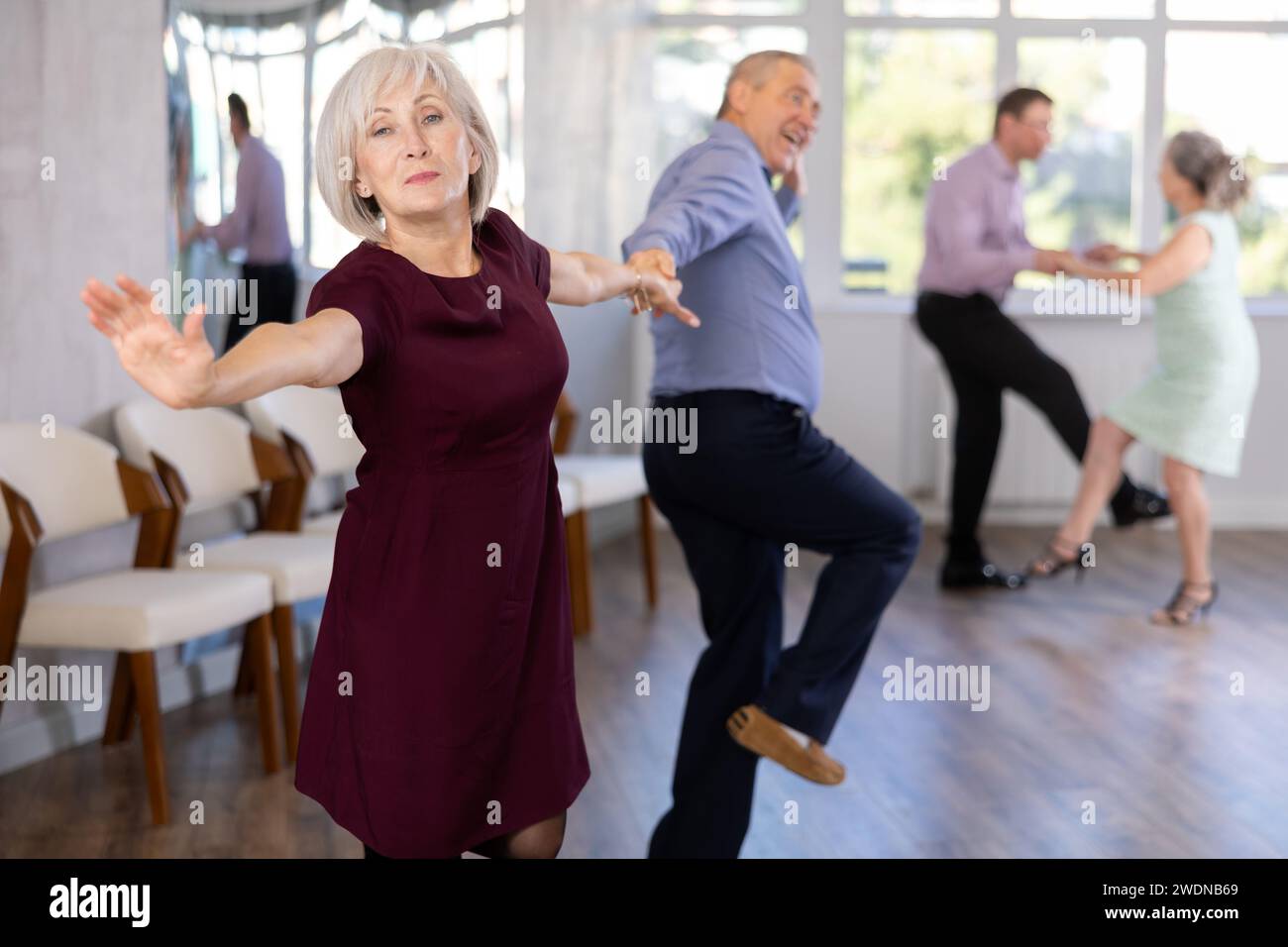 Beautiful mature woman in dance salon studying with her partner to ...