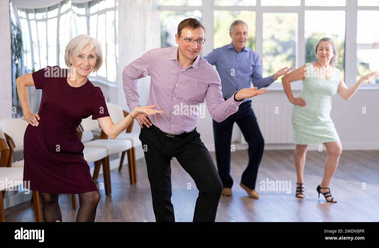 Happy senior woman and man enjoying active boogie-woogie dance in ...