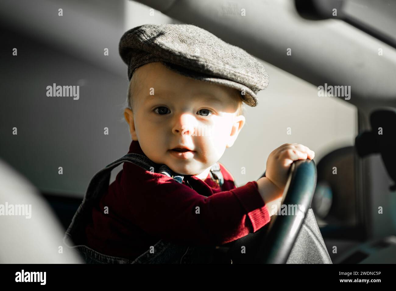Young father with his little son driving car together. Child sit on dad ...