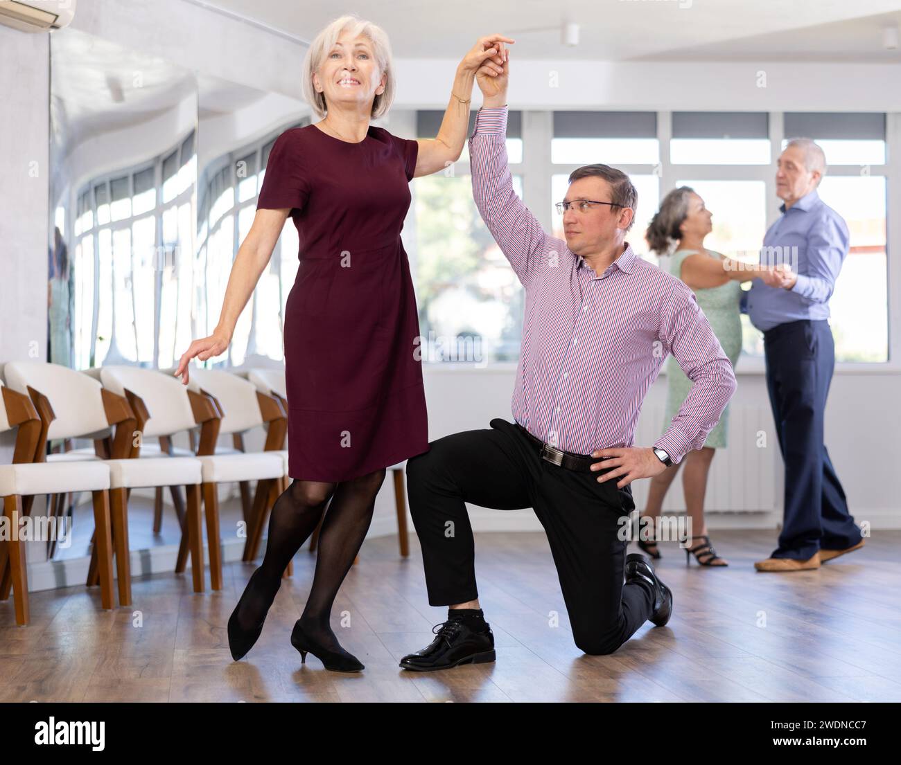 Adult man and elderly woman dance waltz Stock Photo - Alamy