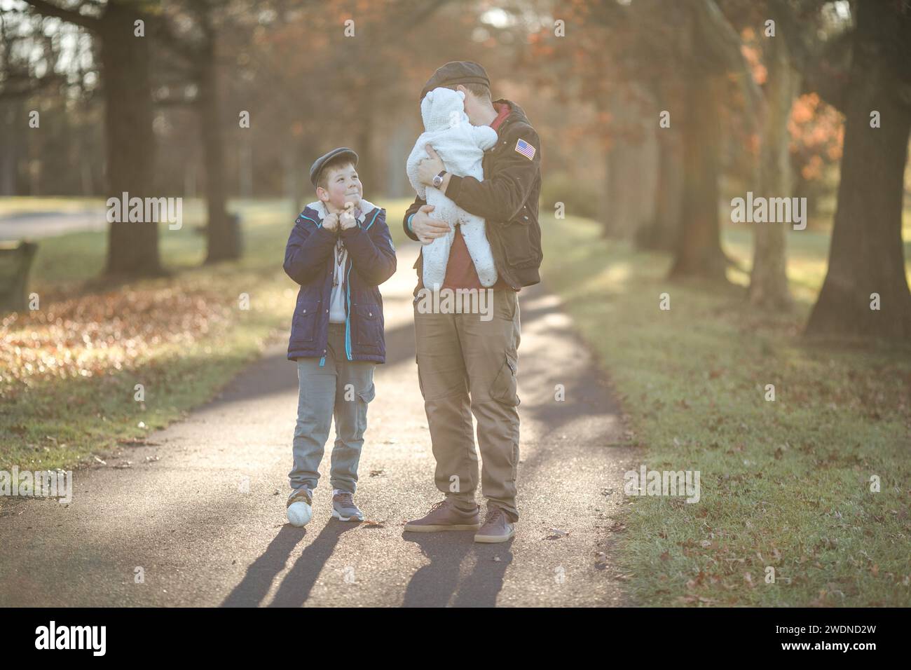 Heartwarming hugs little sons and his father in warm sun shins Stock ...