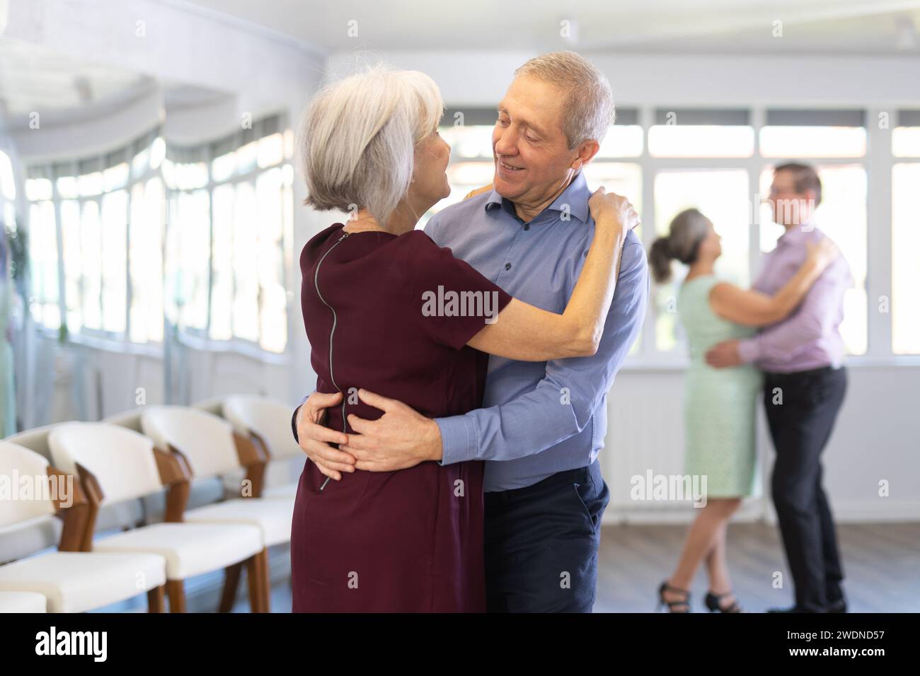 Elderly woman is dancing slow unhurried dance in hugs arms of her ...